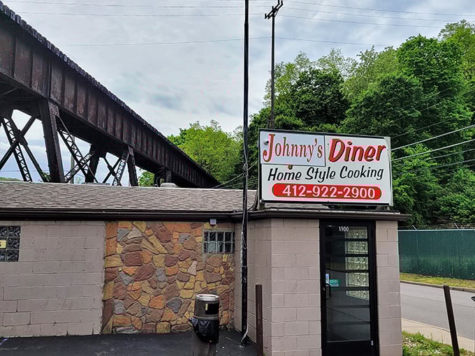 Nestled beneath a rusting railroad trestle, Johnny's Diner looks like it was built on a dare—and thank goodness for that dare.