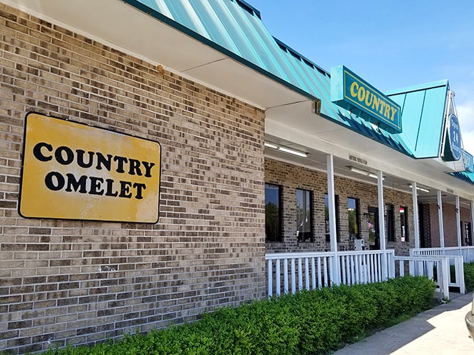 A perfect South Carolina sky frames this temple of breakfast delights, where American flags flutter and hungry patrons eagerly await their morning feast.