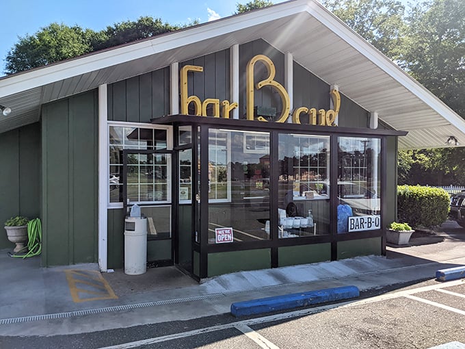 The iconic Bridges Barbecue Lodge in Shelby stands as a true barbecue beacon, its large glass windows offering a tempting peek at the smoky goodness waiting inside.