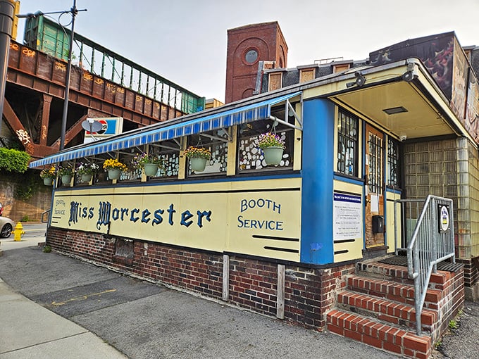 The iconic blue and cream exterior of Miss Worcester Diner stands like a time capsule beneath Worcester's industrial skyline, promising breakfast bliss just steps away.