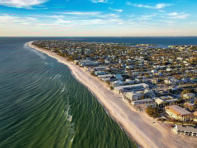 Anna Maria's coastline stretches like nature's perfect smile, where emerald Gulf waters meet powdery white sand on one side and tranquil bay views on the other.