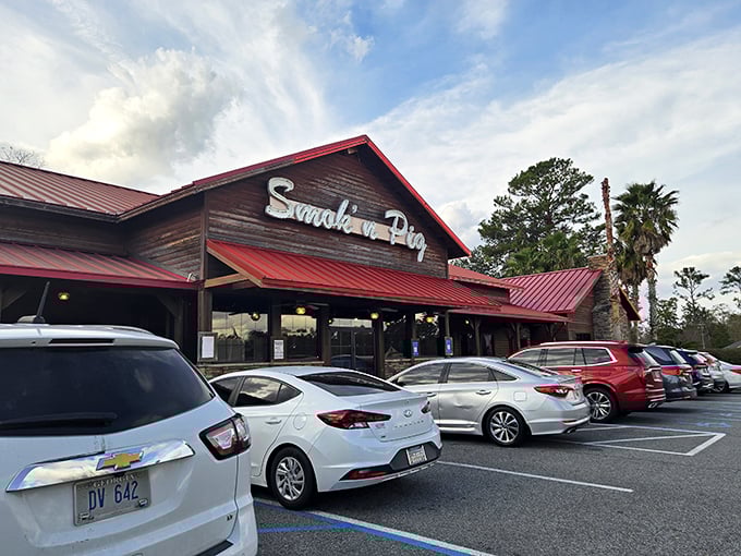 The quintessential Southern BBQ joint beckons with its rustic charm and red metal roof – a carnivore's cathedral where diet plans go to die.