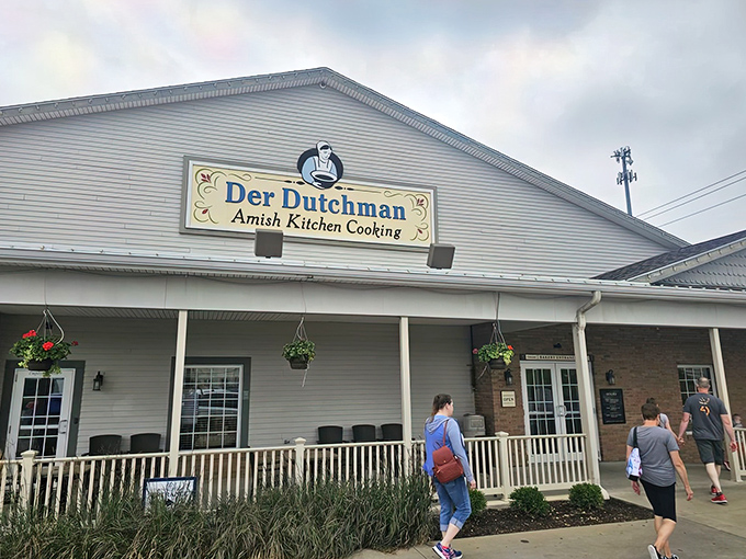 The welcoming facade of Der Dutchman stands like a beacon of comfort food promise in Walnut Creek, where hanging flower baskets add a touch of homey charm.