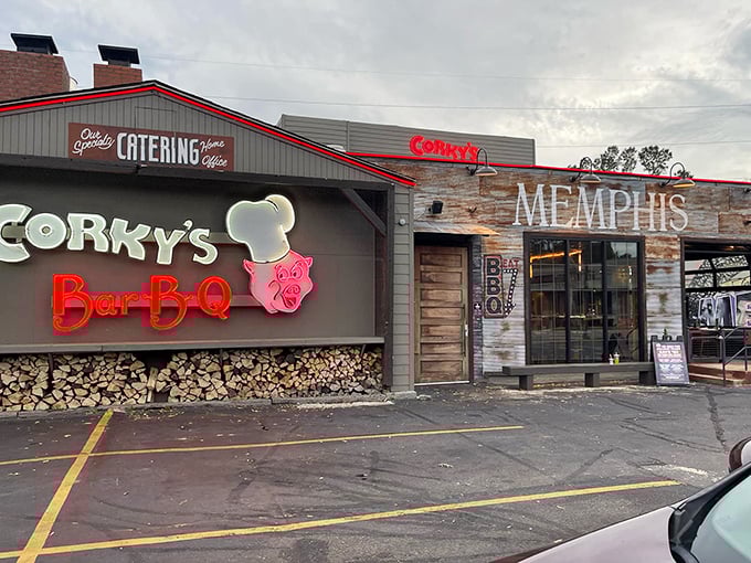 The barbecue beacon of Memphis stands proud with its iconic pig chef logo and stacked woodpile—a smoky promise of deliciousness awaits inside.