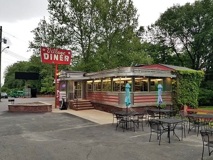 The classic stainless steel exterior of Village Diner gleams like a beacon of comfort food hope along Route 6 in Milford. Time travel never looked so delicious.