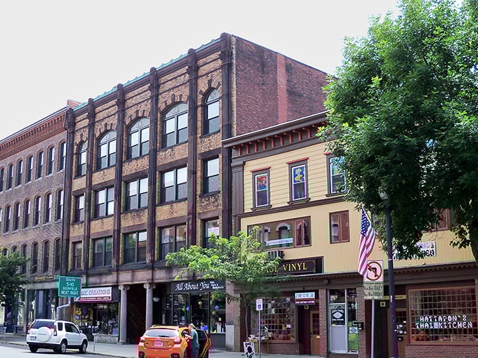 These historic brick facades aren't just pretty—they're living history where vinyl records and local shops thrive instead of being converted to overpriced condos.