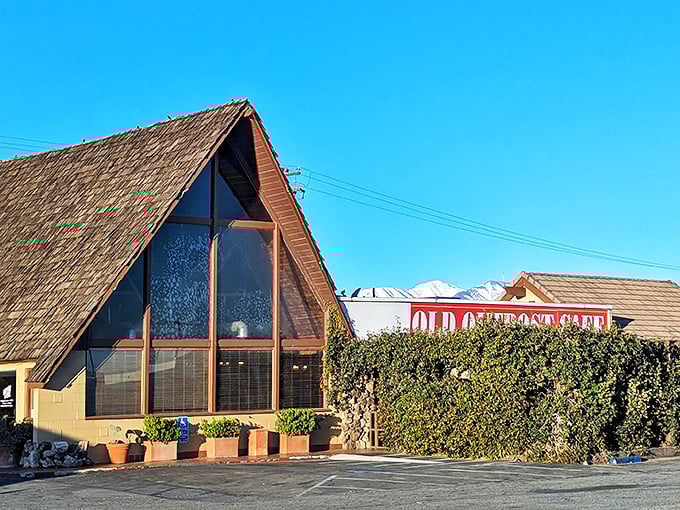 The iconic A-frame structure of Outpost Cafe stands like a delicious mirage in the high desert, promising comfort food salvation to weary Route 66 travelers.