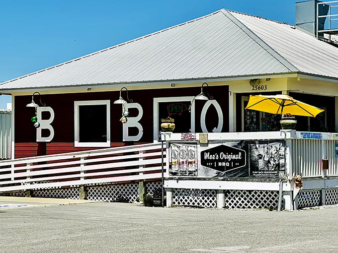 Sun-drenched and inviting, Moe's Original BBQ stands proudly under the Alabama sky, its yellow umbrella promising shade for those about to embark on a flavor journey.