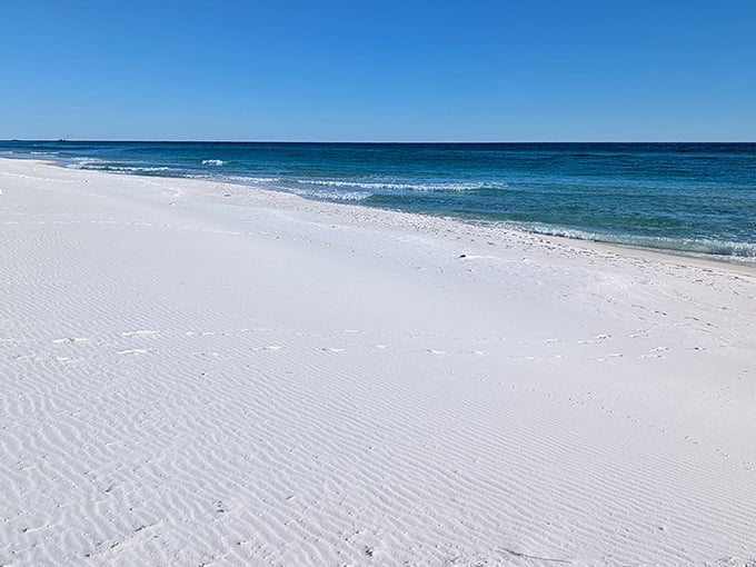 Mother Nature's watercolor masterpiece in action. The gentle turquoise waves of Opal Beach kiss shores so white they'd make a dentist jealous.