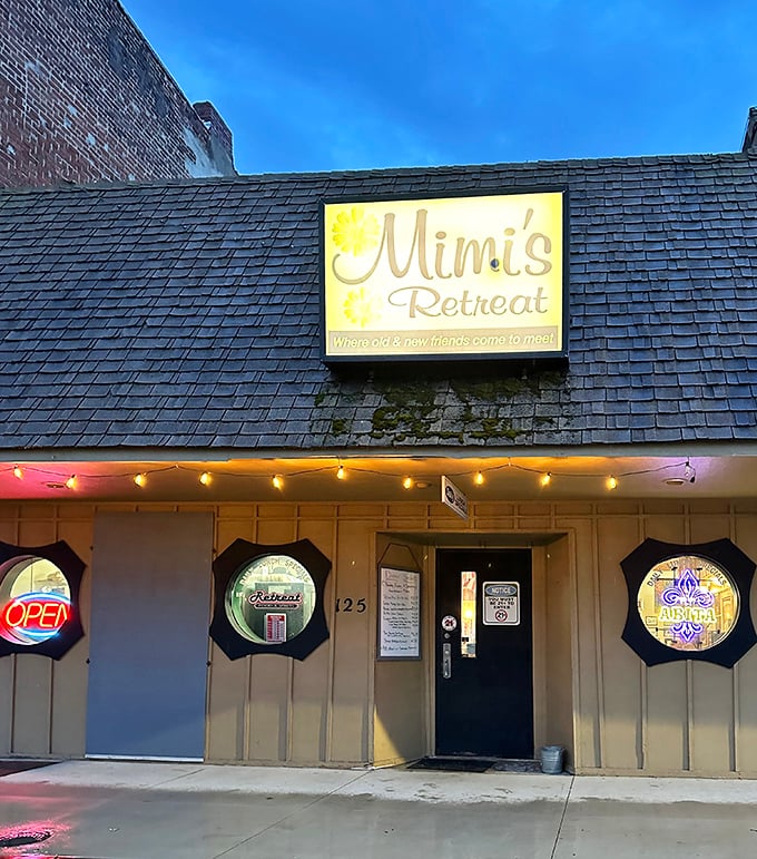 The unassuming exterior of Mimi's Retreat beckons with its glowing sign and porthole windows—proof that culinary treasures often hide in plain sight.