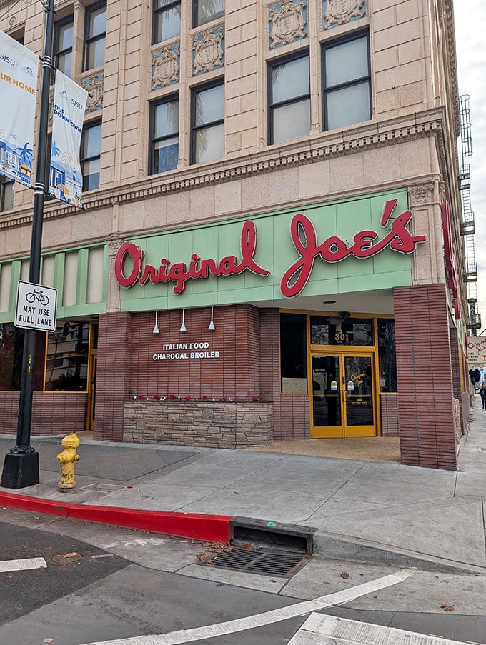The iconic mint-green and red signage of Original Joe's stands as a beacon of culinary promise in downtown San Jose, like a neon-lit love letter to Italian-American cuisine.