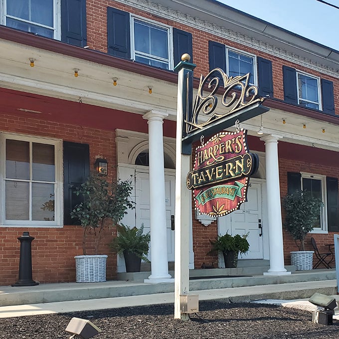 The iconic red brick façade of Harper's Tavern stands as a culinary lighthouse in Annville, beckoning hungry travelers with its vintage neon sign promising good times and better meals.