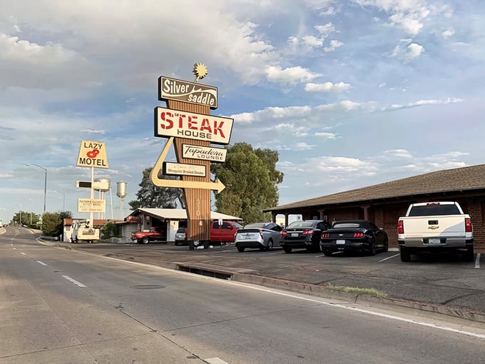 That vintage neon sign isn't just advertising – it's a time machine promising carnivorous delights that have satisfied Tucson appetites for generations.