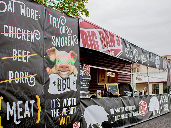 The smiling pig on Big Dan's banner isn't just cute marketing—it's a promise of smoky perfection waiting inside this rustic Catawissa treasure.