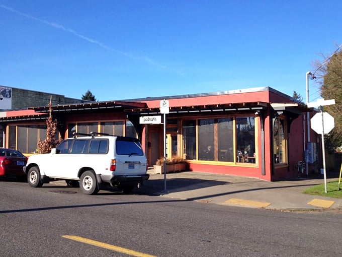 The entrance to barbecue paradise. Those wood stacks flanking the door aren't decorative – they're the secret behind that intoxicating smoky aroma that greets you.