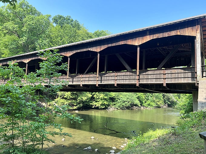 The historic covered bridge at Mohican spans the Clear Fork River like a wooden time machine, inviting visitors to cross into nature's playground.