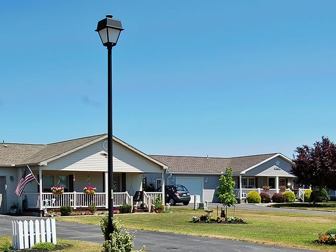 White picket fences and front porch living – Creek View's charming homes embody the American retirement dream with patriotic flair and neighborly proximity.