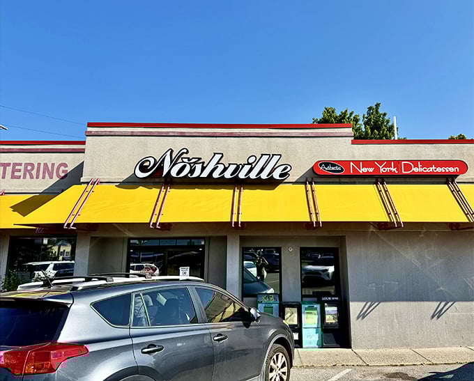 The bright yellow awnings of Noshville beckon like a culinary lighthouse, promising authentic New York deli flavors in the heart of Music City.