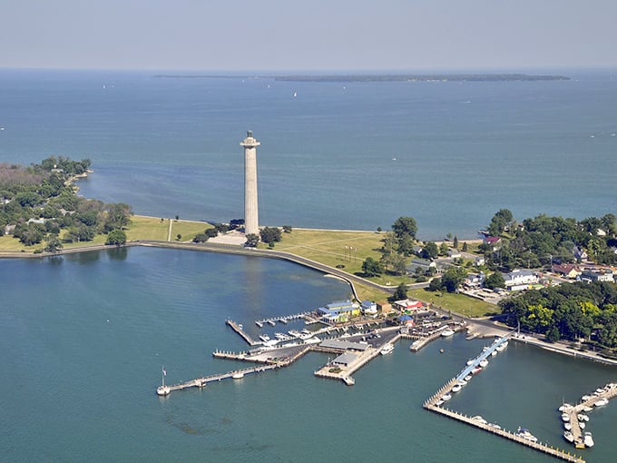 Aerial paradise! Put-in-Bay's harbor sparkles like a sapphire, dotted with boats and framed by Perry's Monument—the Midwest's answer to island getaways.