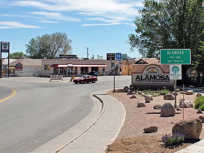 Downtown Alamosa basks in that perfect Colorado sunshine, where historic brick buildings meet mountain views and outdoor dining beckons the hungry traveler.