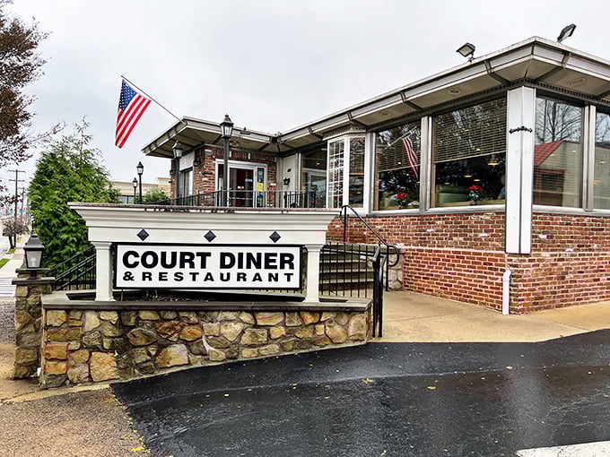 The classic stone and brick exterior of Court Diner stands proudly with its American flag, like a beacon of breakfast hope for hungry Pennsylvanians.