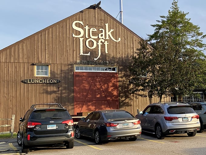 That rustic barn exterior isn't hiding a tractor collection – it's your gateway to steak paradise.