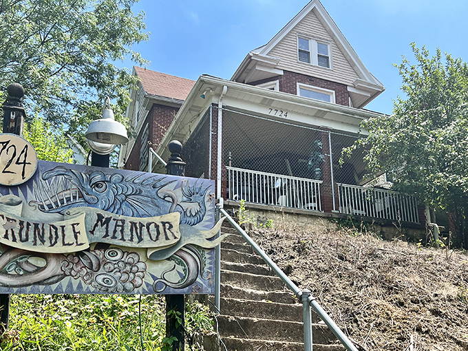 A whimsical sign featuring fantastical creatures welcomes brave visitors to this Pittsburgh oddity. The eyes seem to follow you!