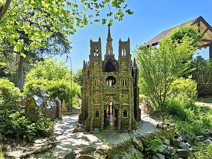 A miniature cathedral rises from the landscape, its stone spires reaching skyward like a medieval dream that somehow landed in Georgia's greenery.