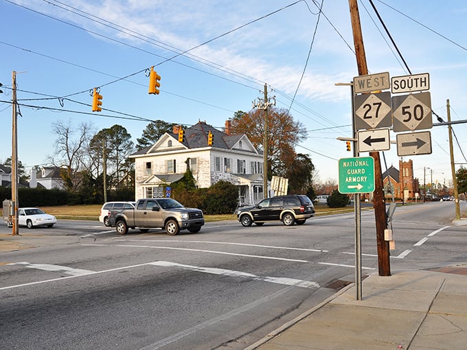 Classic American architecture meets Southern hospitality at this intersection. That white Victorian house isn't just photogenic—it's a testament to Benson's commitment to preserving its historical character.