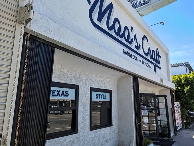 The white facade of Moo's Craft Barbecue announces its Texas-style intentions without pretense—like a barbecue joint that knows actions speak louder than architecture.