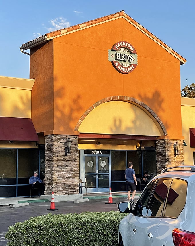 The warm terracotta exterior of Red's beckons like a barbecue beacon in Simi Valley's Sycamore Village, promising smoky treasures within.