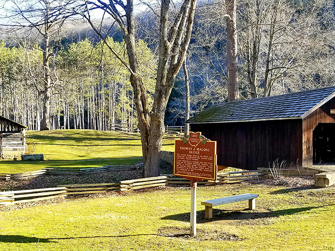 The perfect postcard scene: rustic cabins, a covered bridge, and sunlight filtering through the trees—Mother Nature’s idea of timeless design.