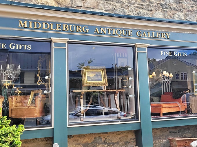 The elegant green and gold façade of Middleburg Antique Gallery beckons like a time portal disguised as a storefront. History waits behind that glass.