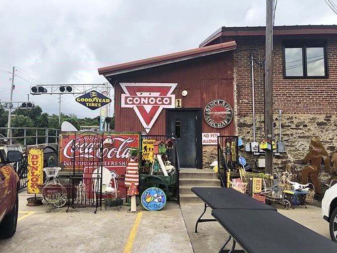 Vintage Conoco and Coca-Cola signs welcome shoppers like old friends, promising nostalgic finds behind that humble door.