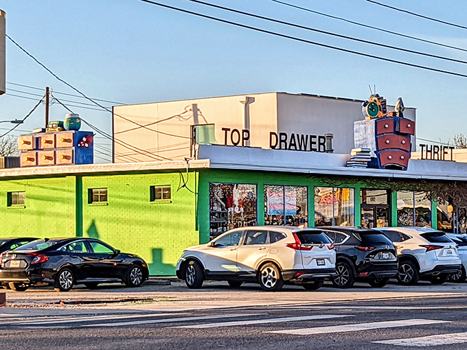The lime green exterior of Top Drawer Thrift isn't just eye-catching—it's practically shouting "treasures inside!" with its whimsical rooftop dresser display.