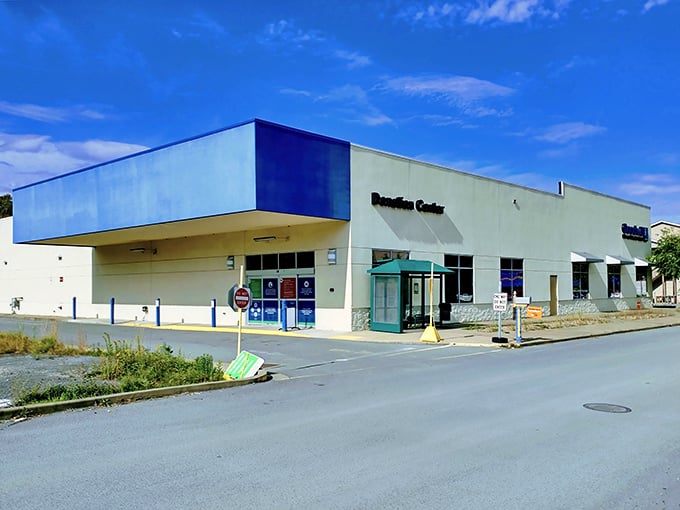The blue-accented exterior of Goodwill in Morgantown stands like a treasure chest waiting to be opened—where bargain hunting adventures begin and wallets breathe sighs of relief.