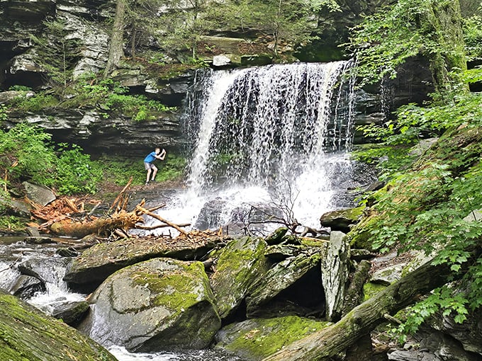 Nature's own masterpiece – a waterfall framed by ancient rock walls and vibrant greenery. Pennsylvania's version of paradise found.