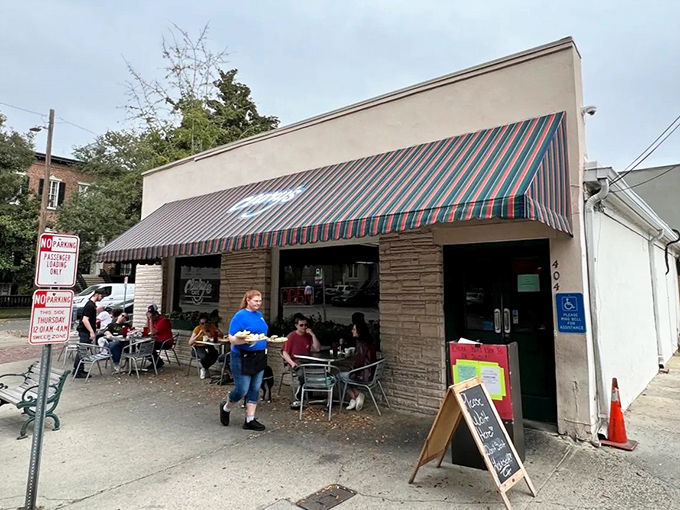 The striped awning of Clary’s Cafe shines like a breakfast beacon, guiding hungry souls through Savannah’s historic streets.