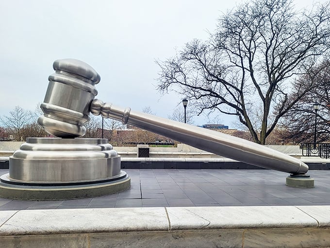 The World's Largest Gavel gleams in winter light, a 30-foot metallic monument to justice that makes even the most innocent visitor contemplate their parking tickets.