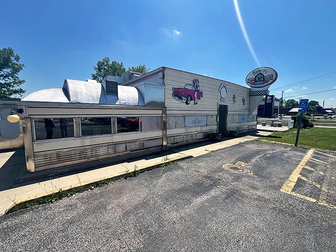 Nancy’s Main Street Diner, with its sunny yellow walls and classic car murals, is a time machine disguised as a diner—just park your imaginary Thunderbird out front.