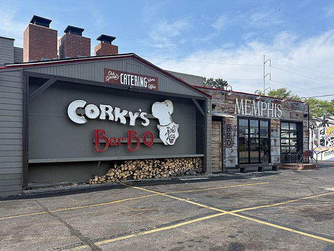 The barbecue beacon of Memphis stands proud with its iconic pig chef logo and stacked woodpile—a smoky promise of deliciousness awaits inside.