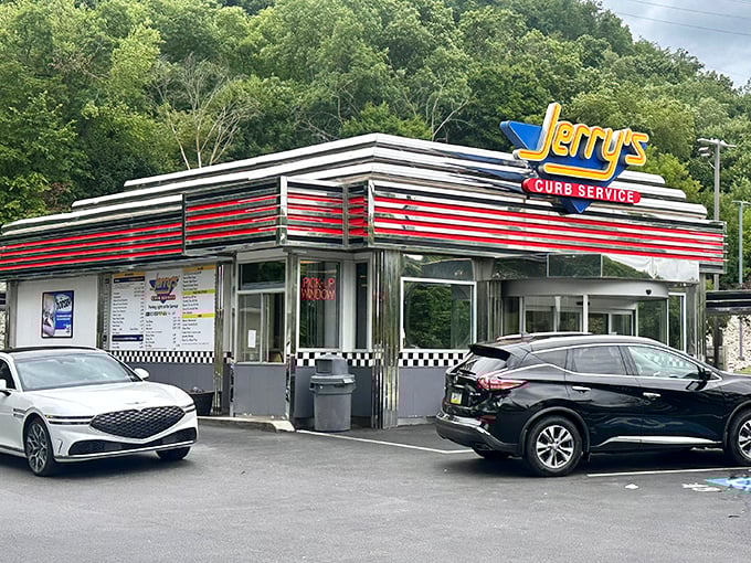 The gleaming red and silver stripes of Jerry's Curb Service stand as a time portal to America's golden age of drive-ins. No DeLorean required.