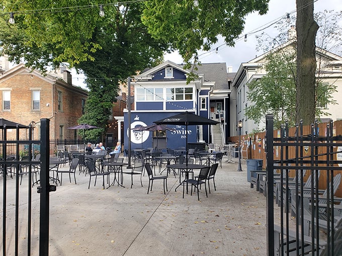 The inviting patio at The Swire Inn beckons with its charming tables and blue facade—Ohio's answer to European cafe culture.
