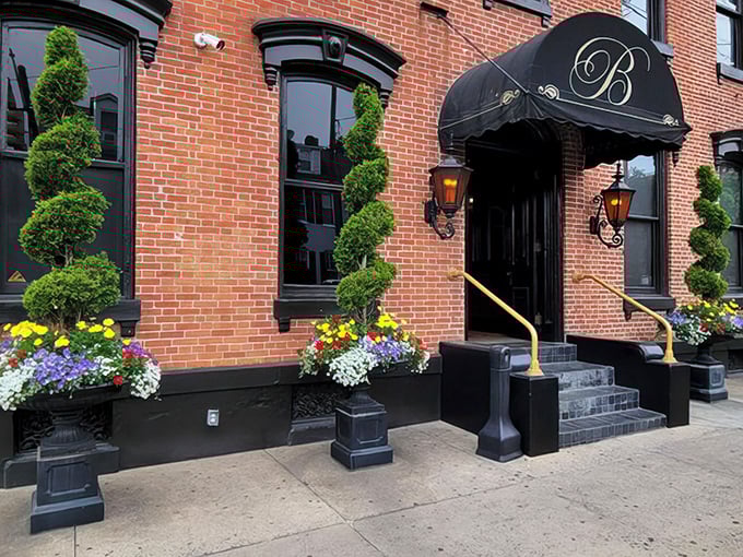 Victorian elegance meets culinary adventure at The Belvedere's entrance, where spiral topiaries stand like maître d's welcoming you to Lancaster's dining gem.