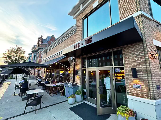 The brick façade of Cork & Fork beckons like an old friend on Harrisburg's Second Street, promising culinary adventures behind those welcoming doors.
