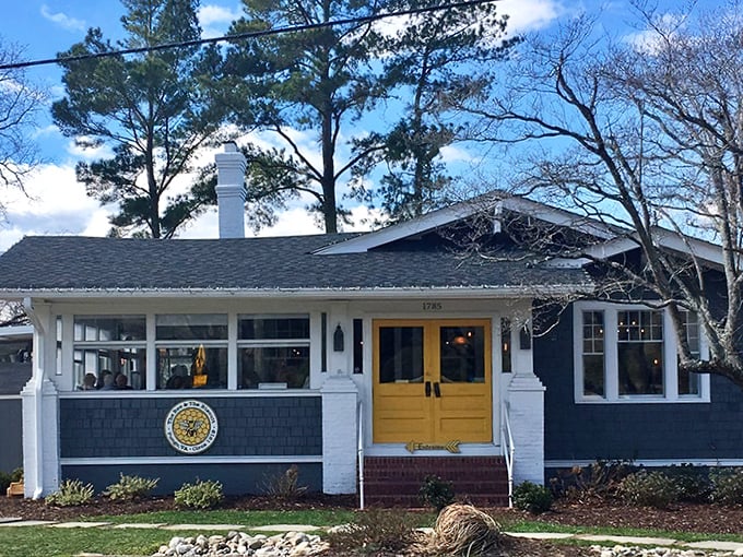 The navy blue cottage with that sunshine-yellow door isn't just Instagram bait—it's your portal to breakfast nirvana in Virginia Beach's Pungo neighborhood.