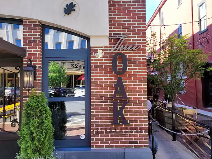 The brick facade of Three Oak Steakhouse welcomes you with elegant metal lettering and lush greenery—like a sophisticated friend inviting you in for dinner.