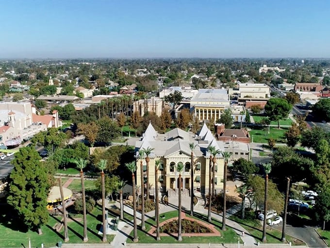 Hanford's historic courthouse stands like a castle in California's Central Valley, surrounded by stately palms that seem to whisper, "Slow down, you're home now."