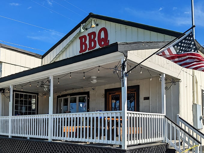The welcoming front porch of BBQ Exchange beckons with its simple charm and promise of smoky delights waiting just beyond those doors.