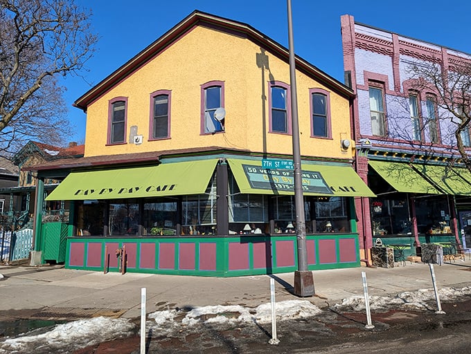 That distinctive yellow building with green awnings isn't trying to be trendy—it's too busy being exactly what a neighborhood cafe should be.